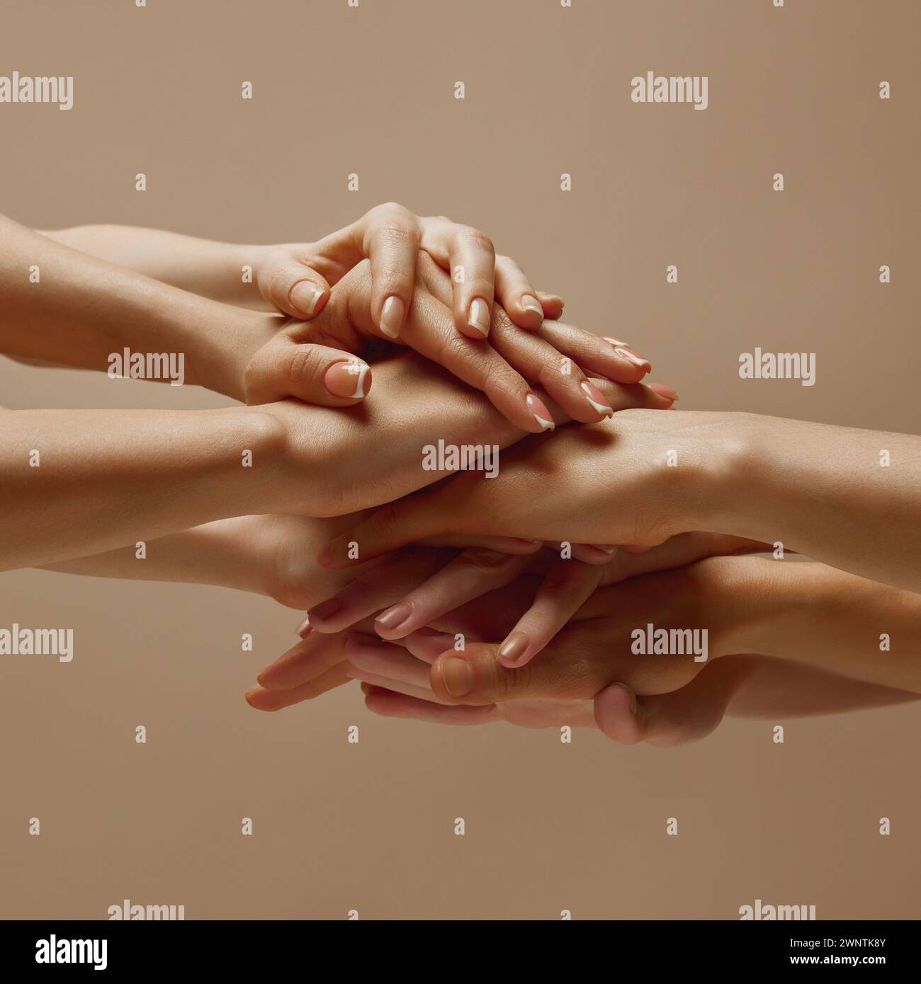 Various woman puts his hands together showcasing unity, teamwork and ...