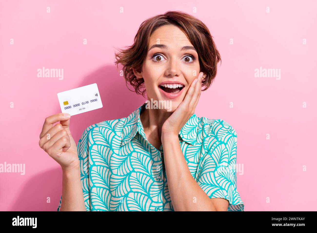 Photo of impressed positive person hand touch cheek hold plastic debit ...