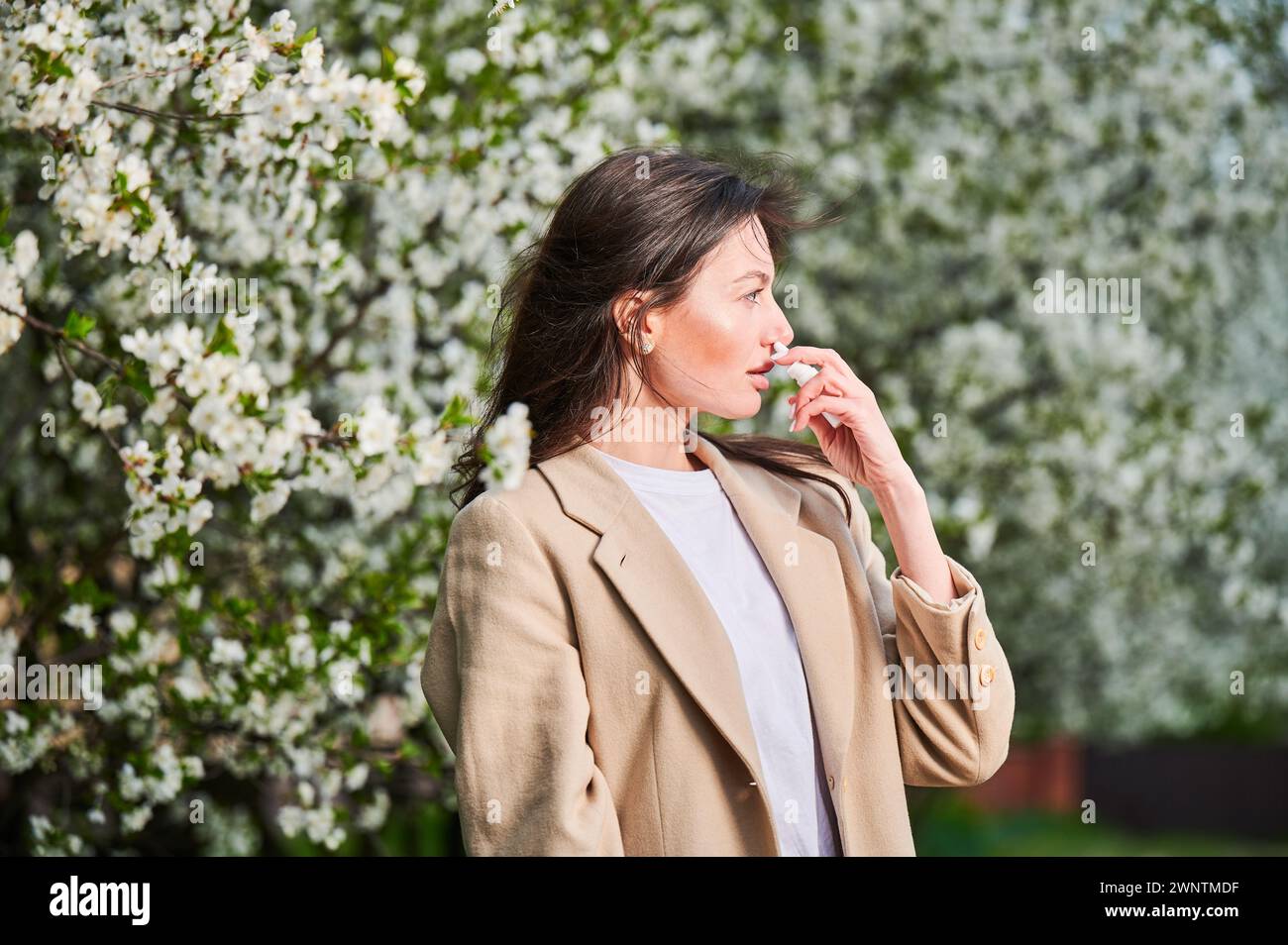 Woman allergic using medical nasal spray, suffering from seasonal ...