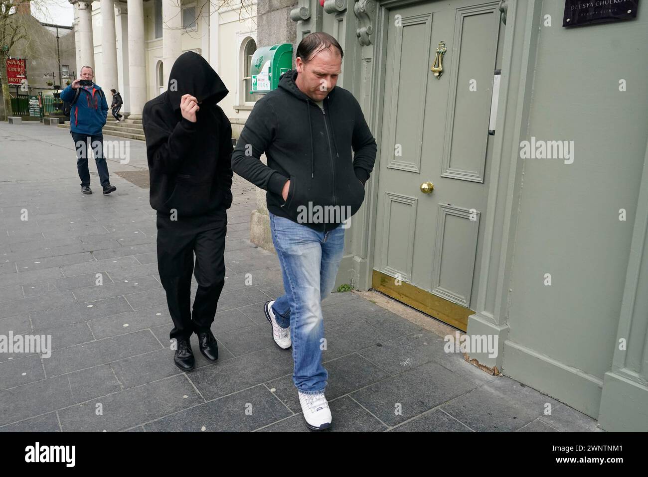 Daniel Quinn Burke (left) leaves Naas District Court, Co Kildare, where three men are appearing ...