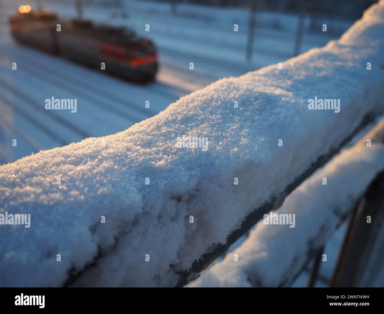 Snow, crust and frozen crust on metal railings. Suspension bridge over ...