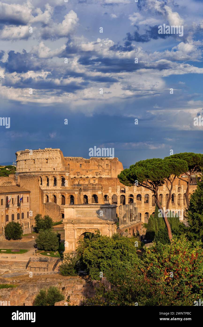 Colosseum and Arch of Titus at sunset in city of Rome, Italy. Ancient ...