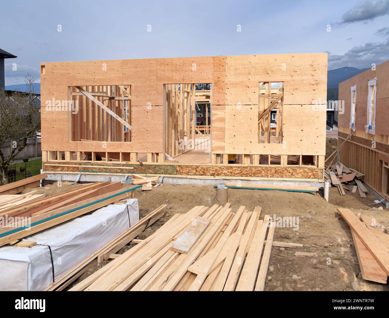Wooden frame of a new house with engineered lumber materials in front ...