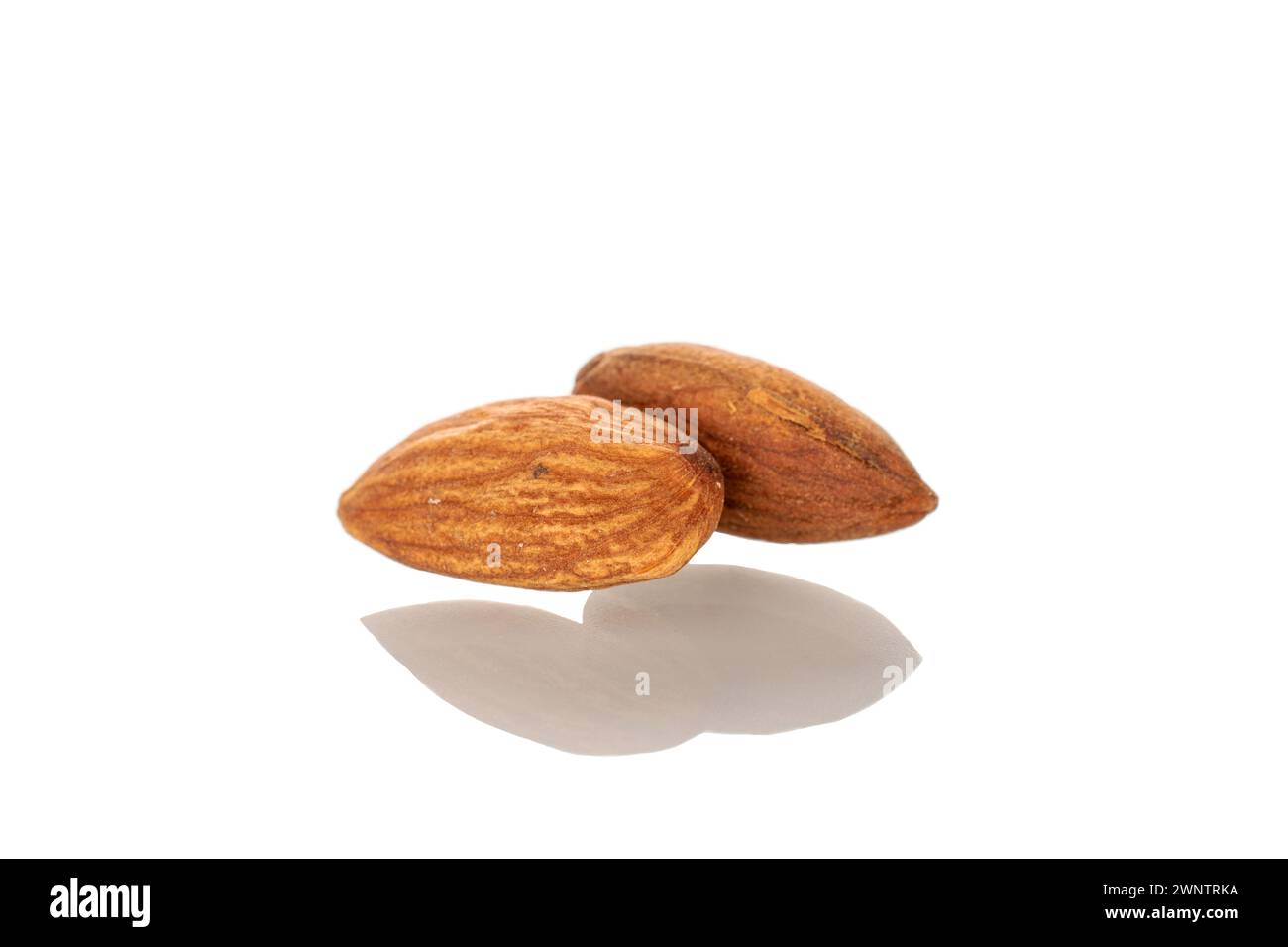 Two roasted almonds, macro, isolated on white background Stock Photo ...