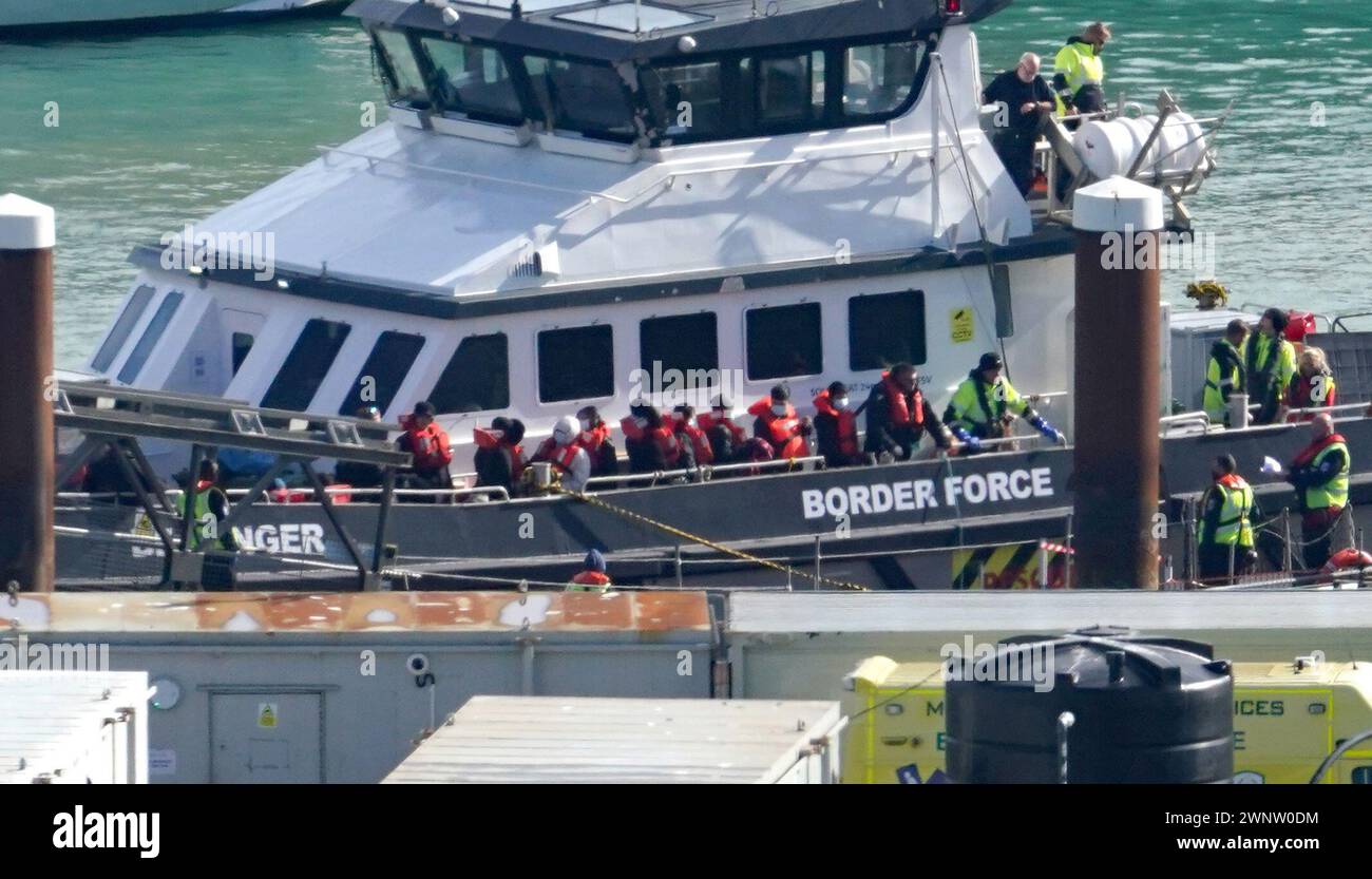 A group of people thought to be migrants are brought in to Dover, Kent ...