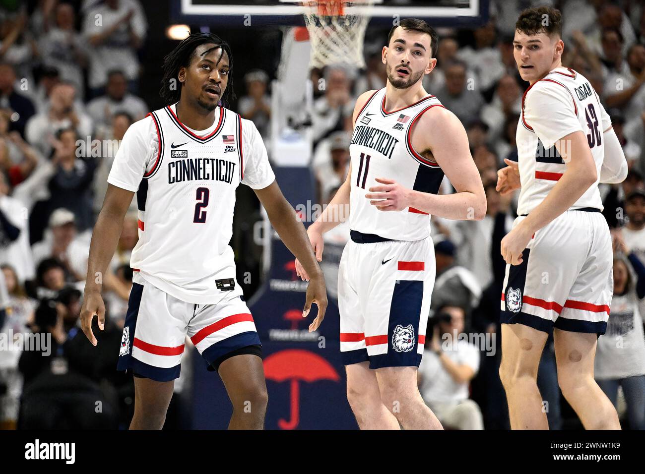 UConn guard Tristen Newton (2), UConn forward Alex Karaban (11), and ...