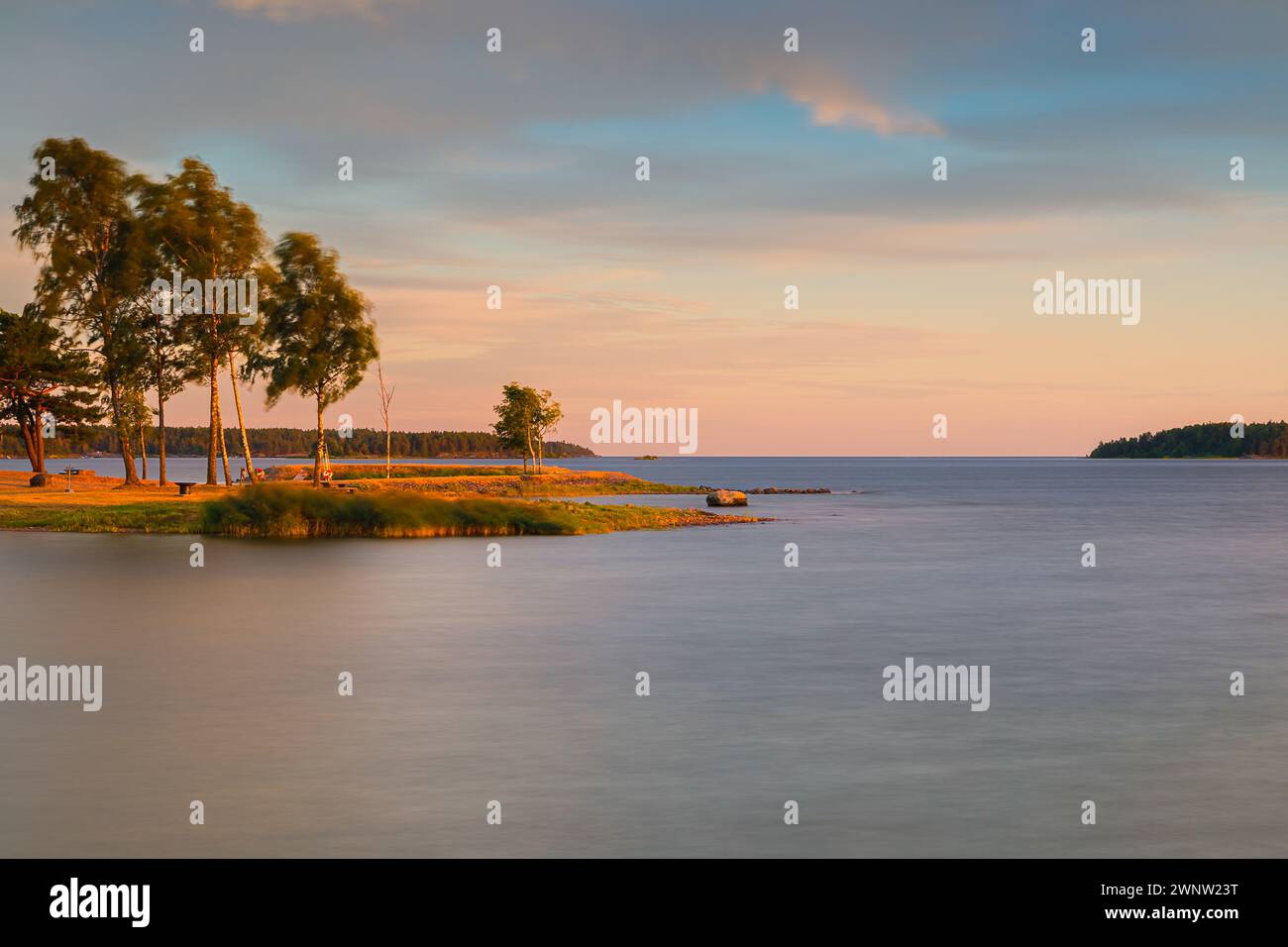 A summer evening sunset at Lake Vänern, the largest lake in Sweden and ...