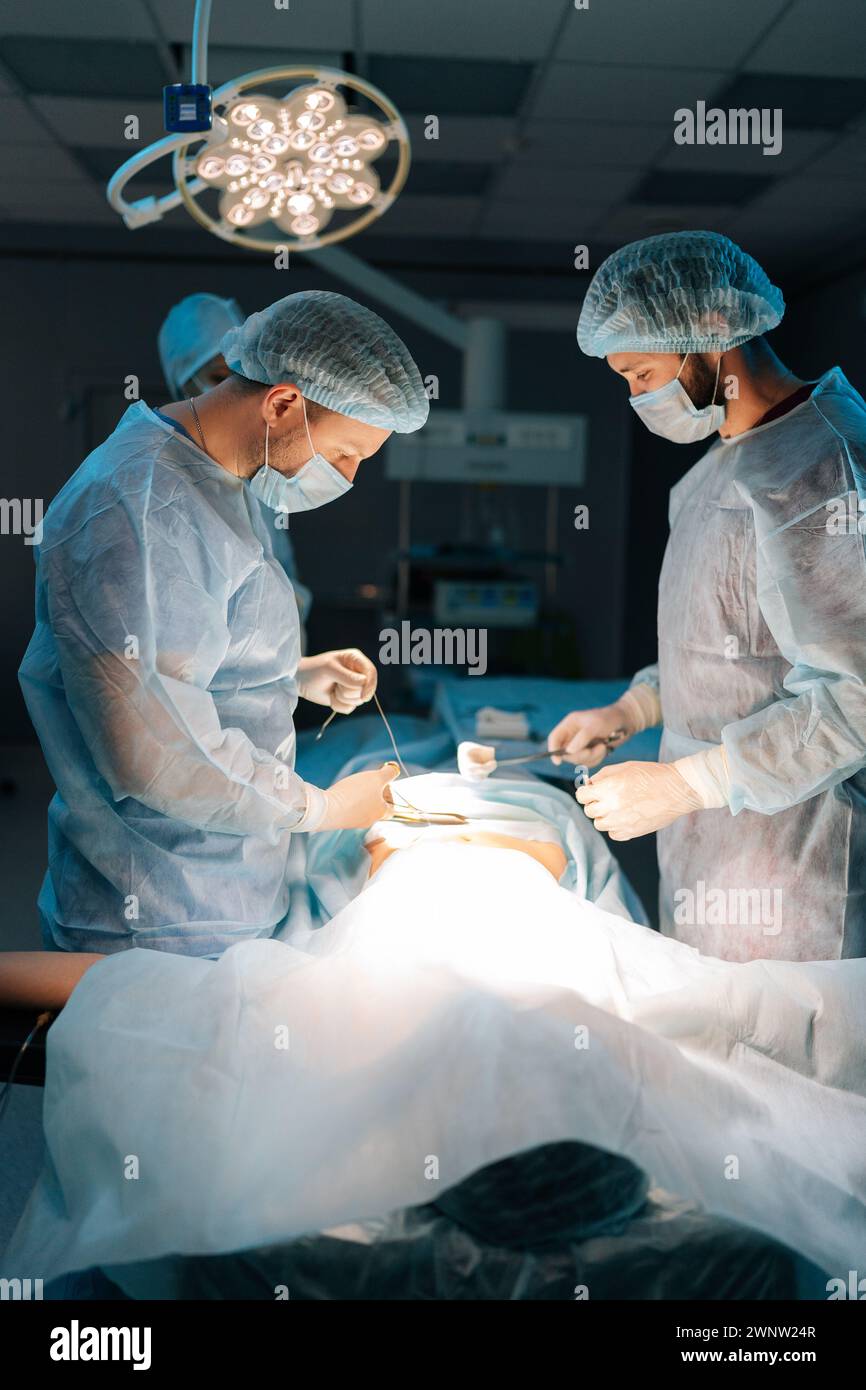 Vertical shot of multiethnic team of professional male surgeons and ...