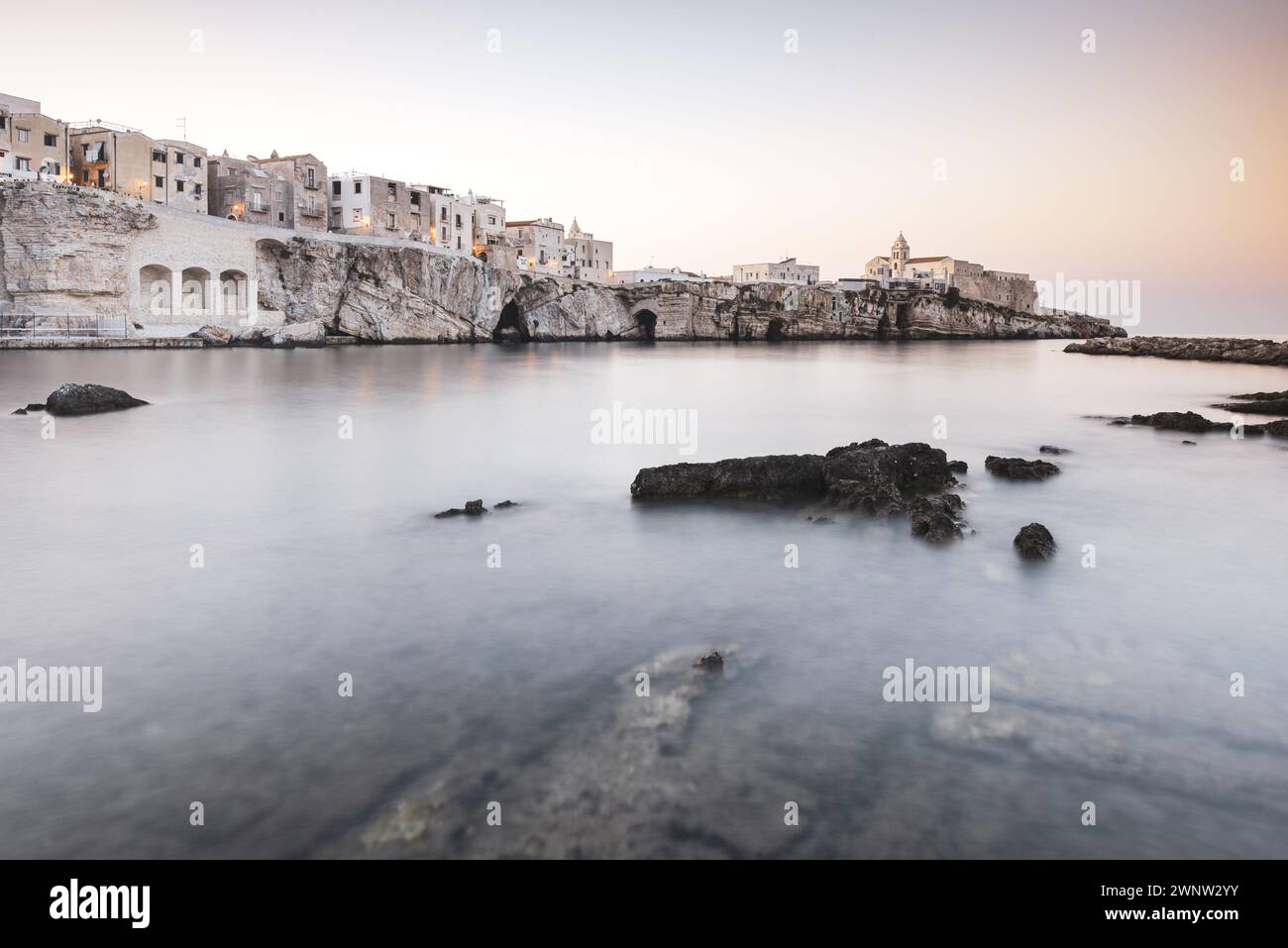 ITALY, PUGLIA, VIESTE: Sunset panoramic view of the old town of Vieste ...