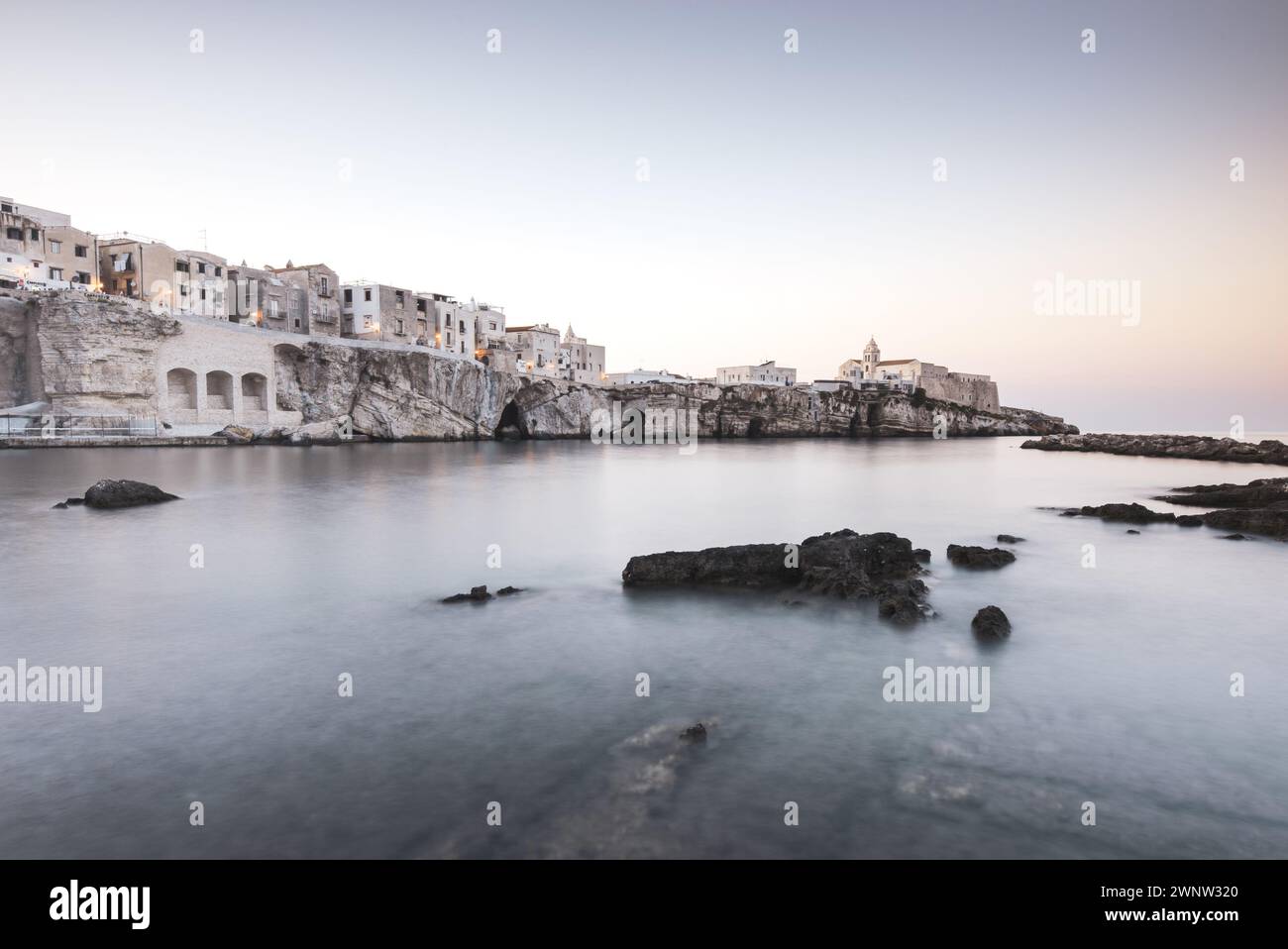 ITALY, PUGLIA, VIESTE: Sunset panoramic view of the old town of Vieste ...