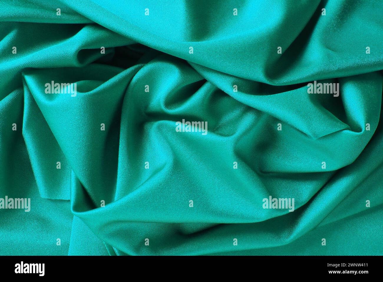 Green silk fabric texture background. Beautiful folds on the material ...