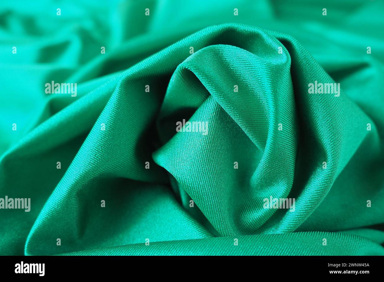 Green silk fabric texture background. Beautiful folds on the material ...