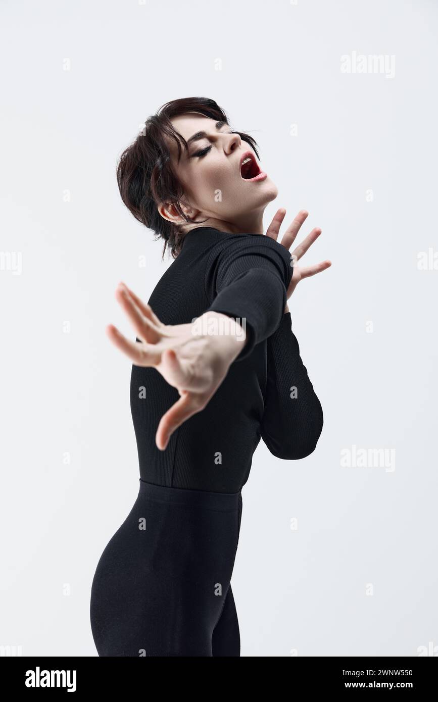 Expressive woman with outstretched hands, eyes closed and mouth open ...