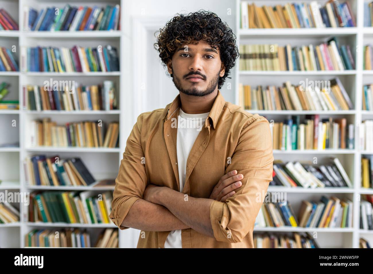 A poised person stands with arms folded , demonstrating confidence and ...