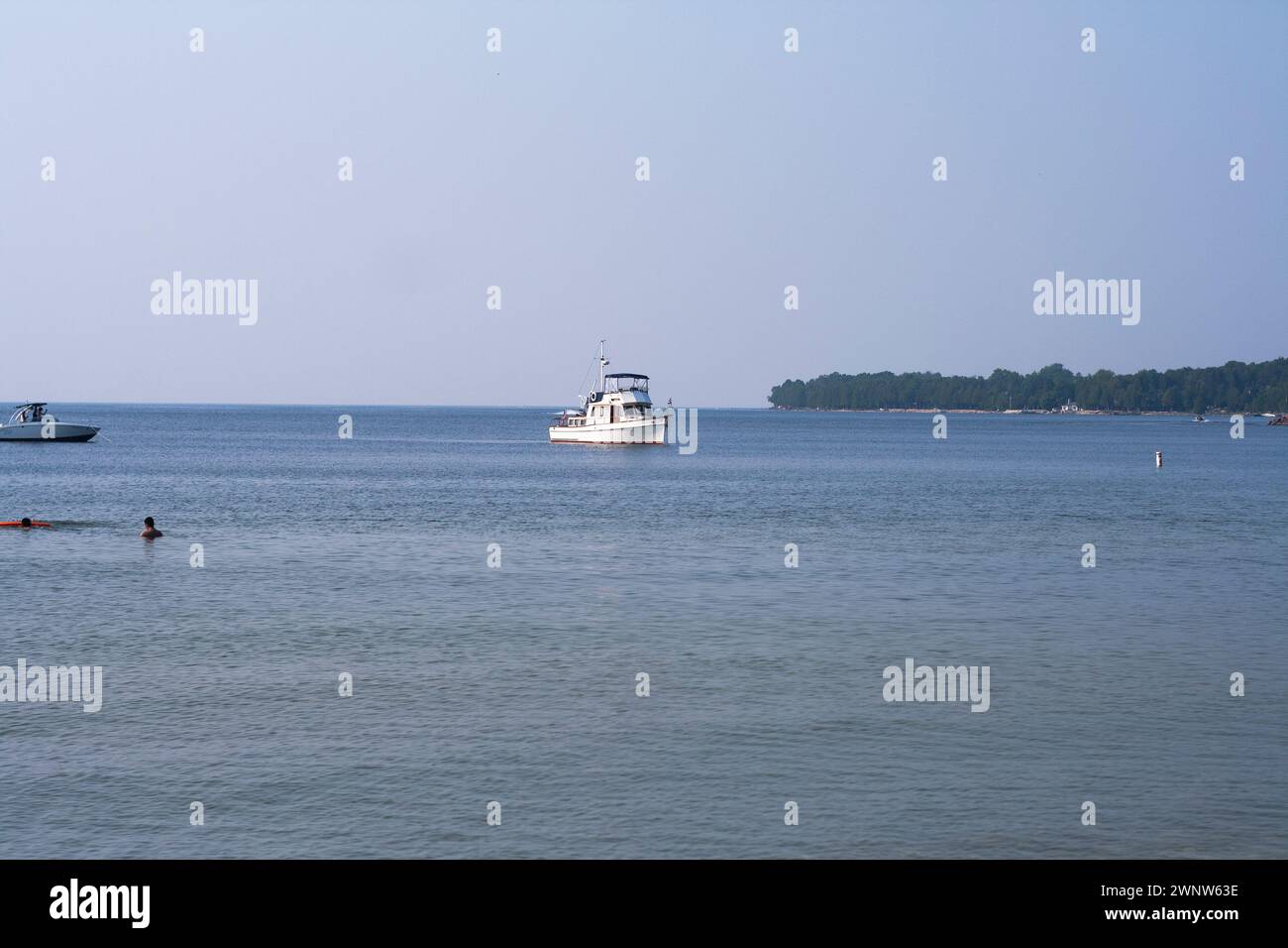 People boating and swimming in Lake Michigan off of Egg Harbor Beach in ...