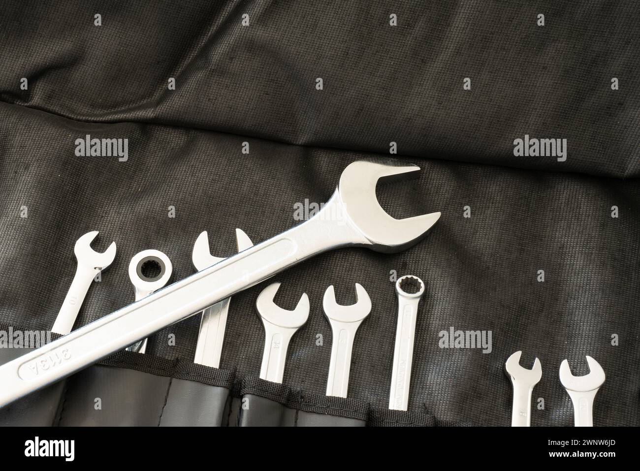 Set of wrenches in different sizes in black tools back. One wrench ...