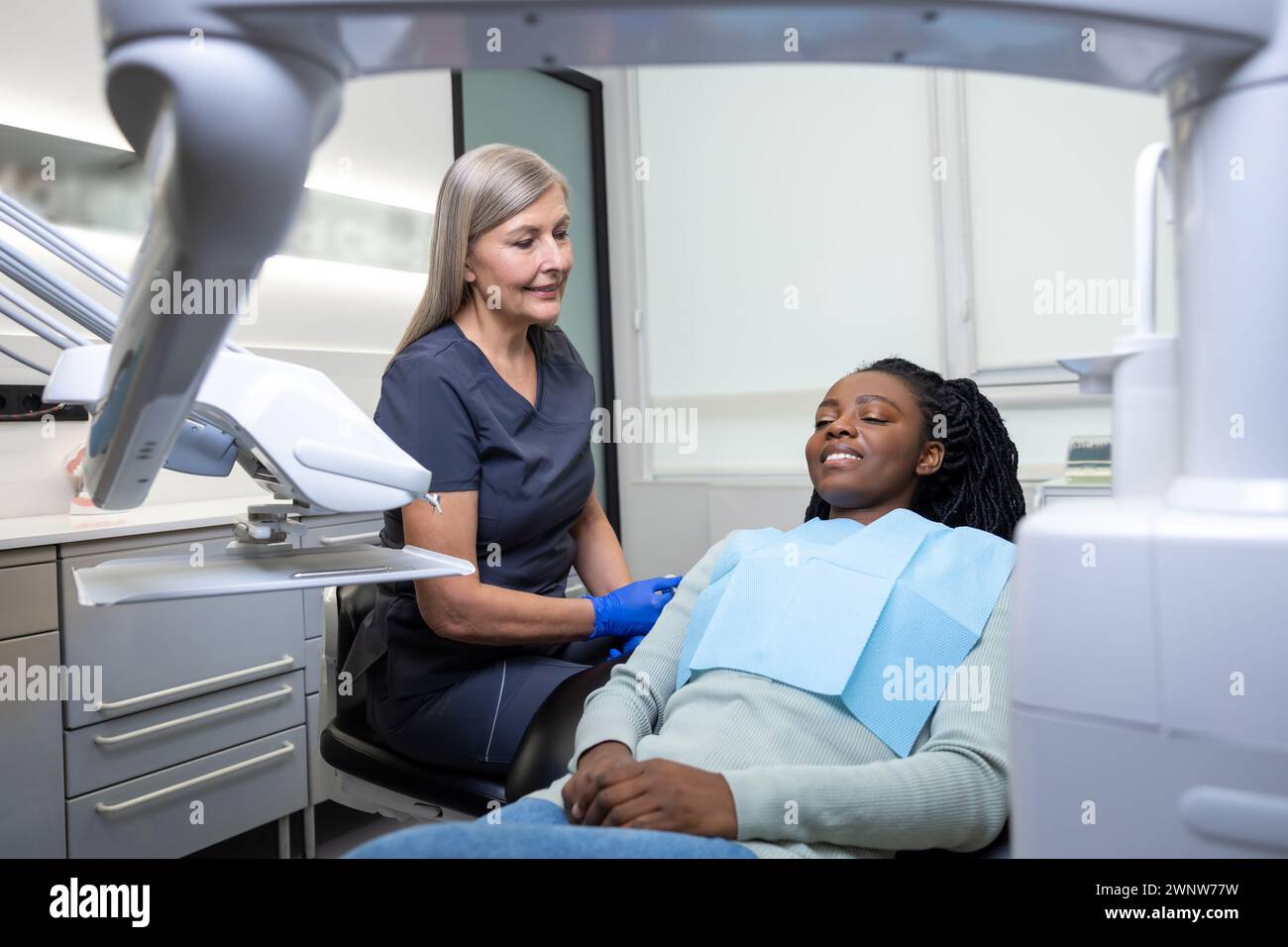Multicultural lady in dental clinic doing teeth checkup Stock Photo - Alamy