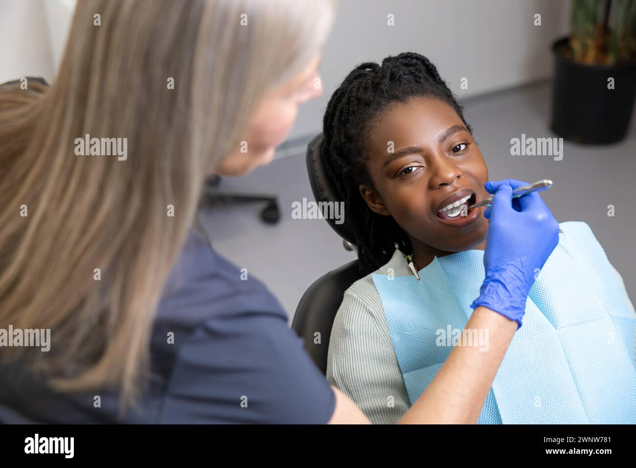 Multicultural lady in dental clinic doing teeth checkup Stock Photo - Alamy