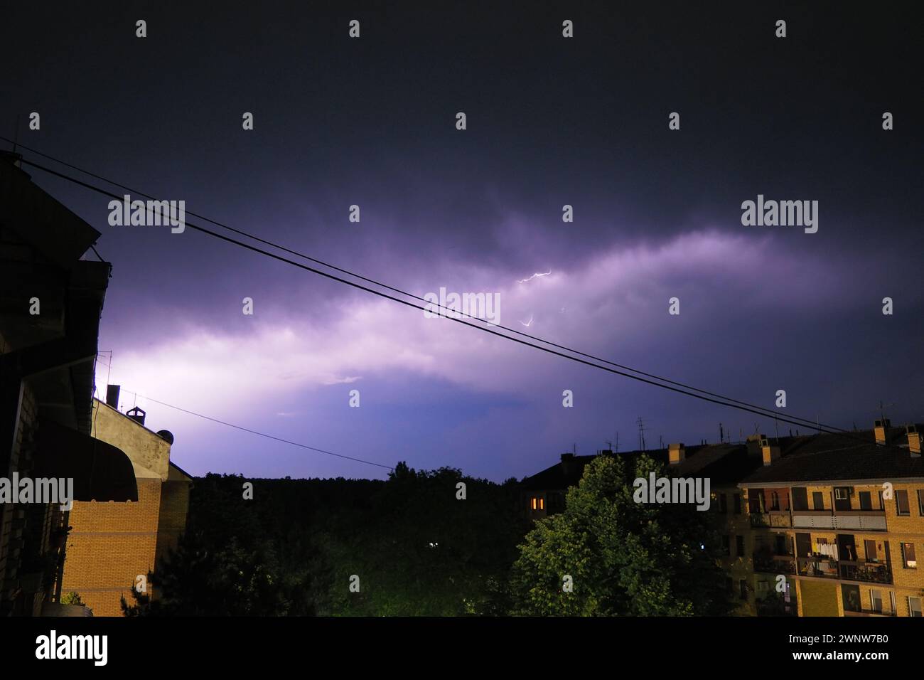 Thunderstorm at night over the city. Flashes of lightning and low ...