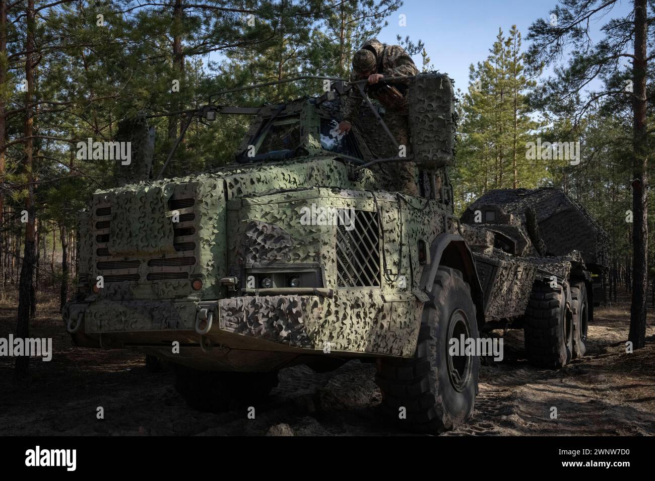 A Ukrainian soldier cleans the window of a Swedish self-propelled ...