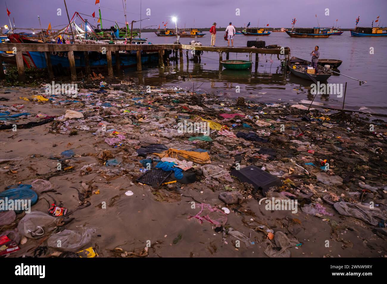 The dirty beach of the fishing harbor of Hoi An in Vietnam Stock Photo ...