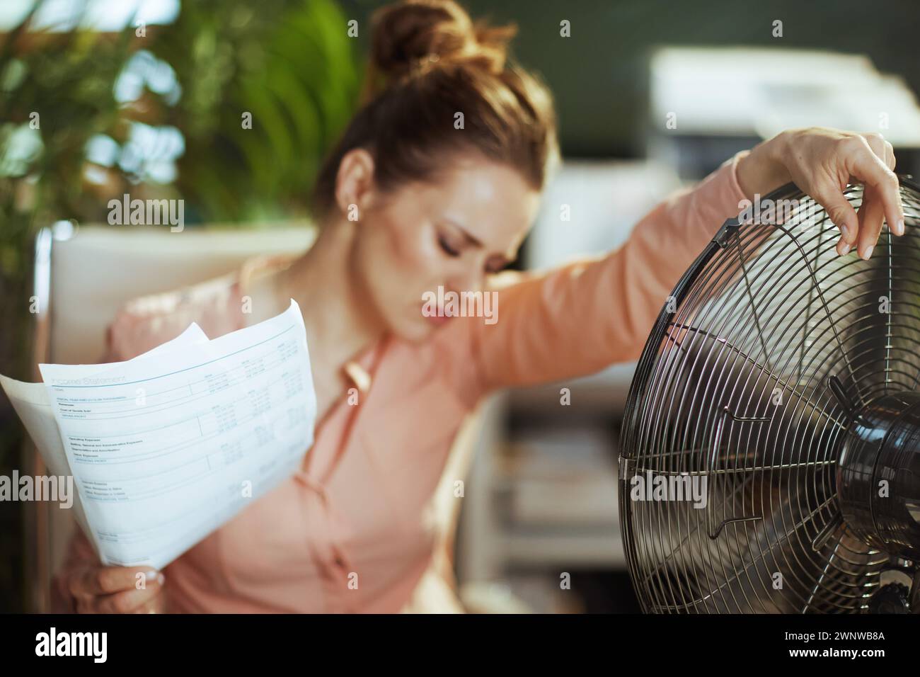 Sustainable workplace. modern woman worker in modern green office with ...