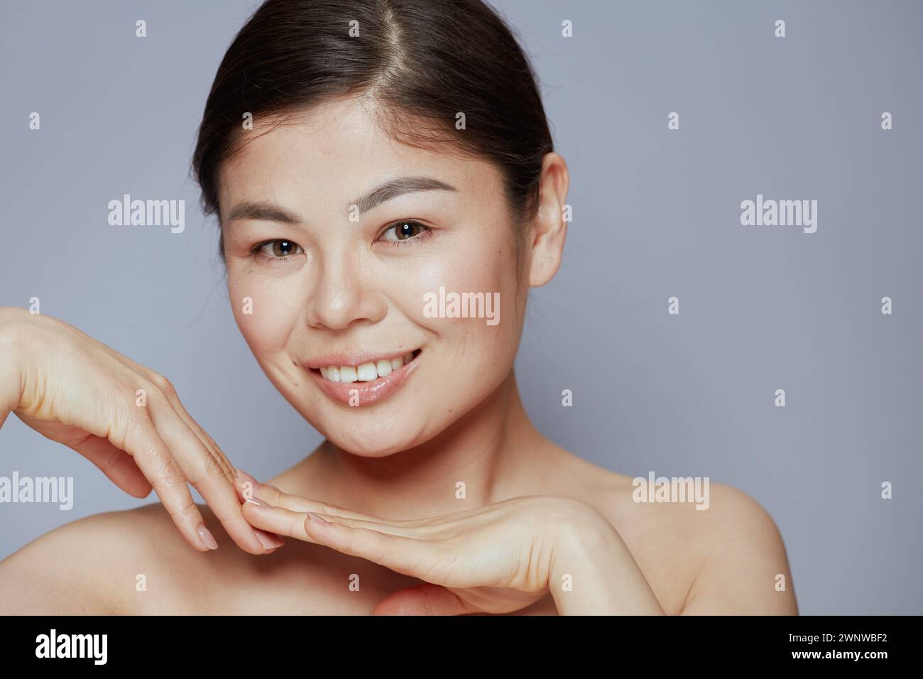 Portrait of modern asian woman against blue background Stock Photo - Alamy