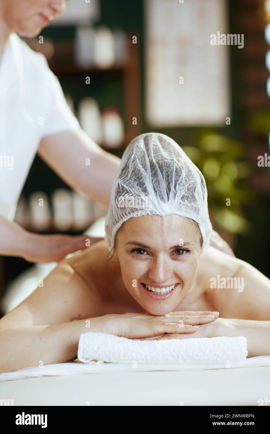 Healthcare time. massage therapist in massage cabinet with happy client massaging clients back ...