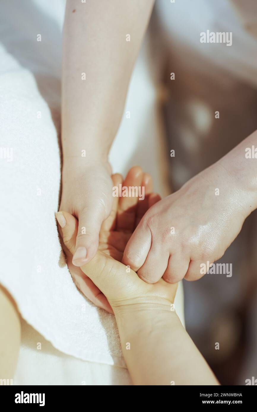 Healthcare time. Closeup on medical massage therapist in spa salon massaging clients hand Stock ...