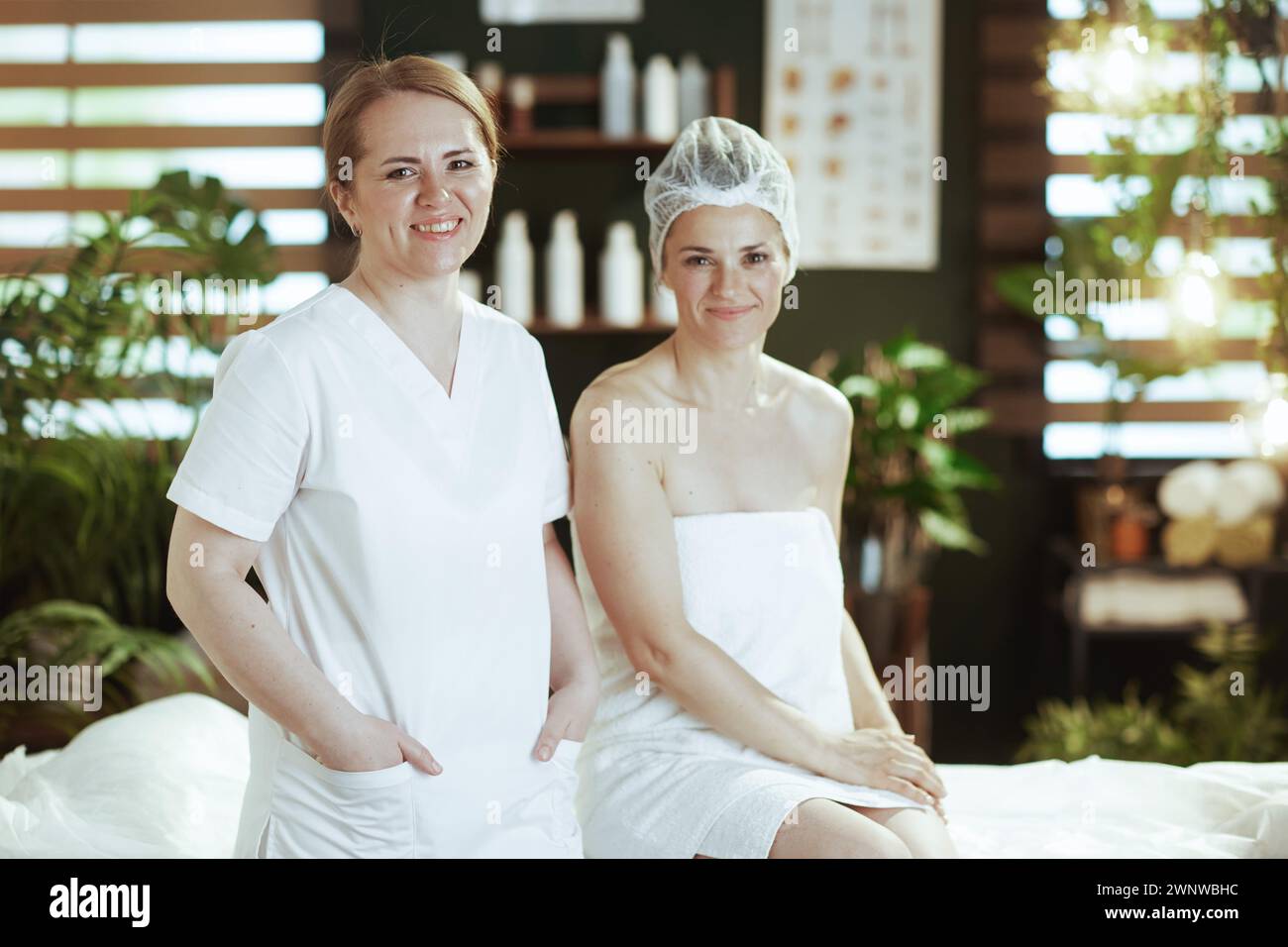 Healthcare time. medical massage therapist in spa salon with relaxed ...