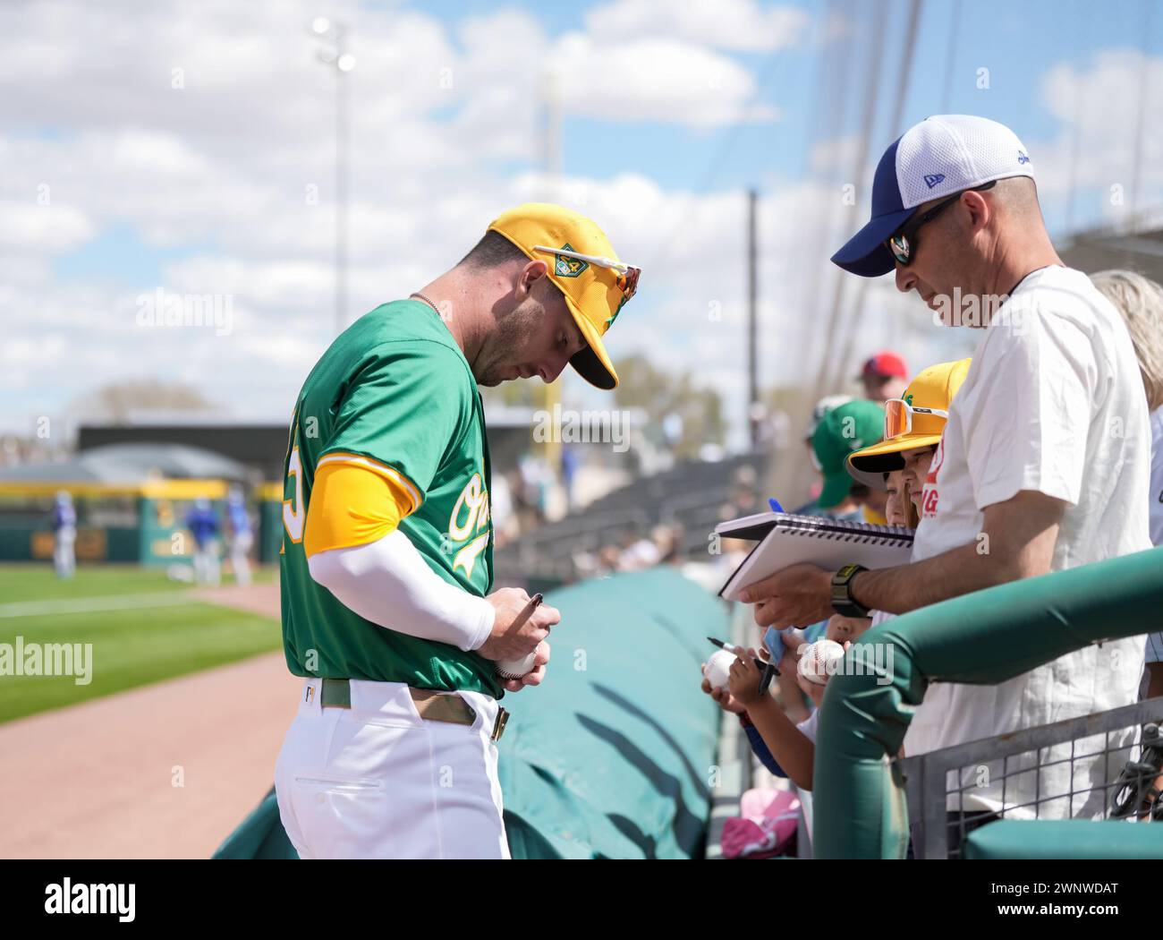 Brent Rooker (25) of the Oakland Athletics signs autographs before the ...