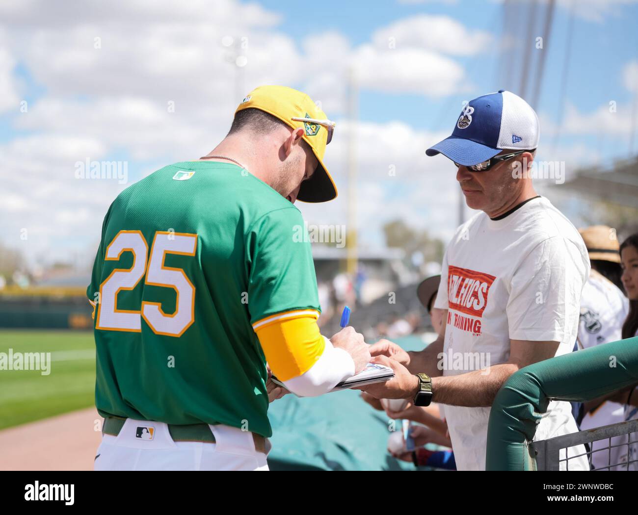 Brent Rooker (25) of the Oakland Athletics signs autographs before the ...