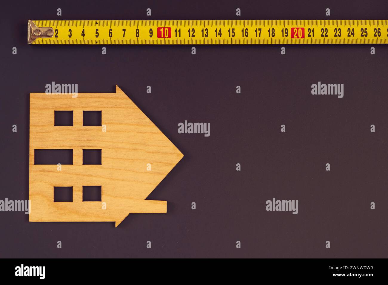 The image of the house on the background. Measurement of the size, tape ...