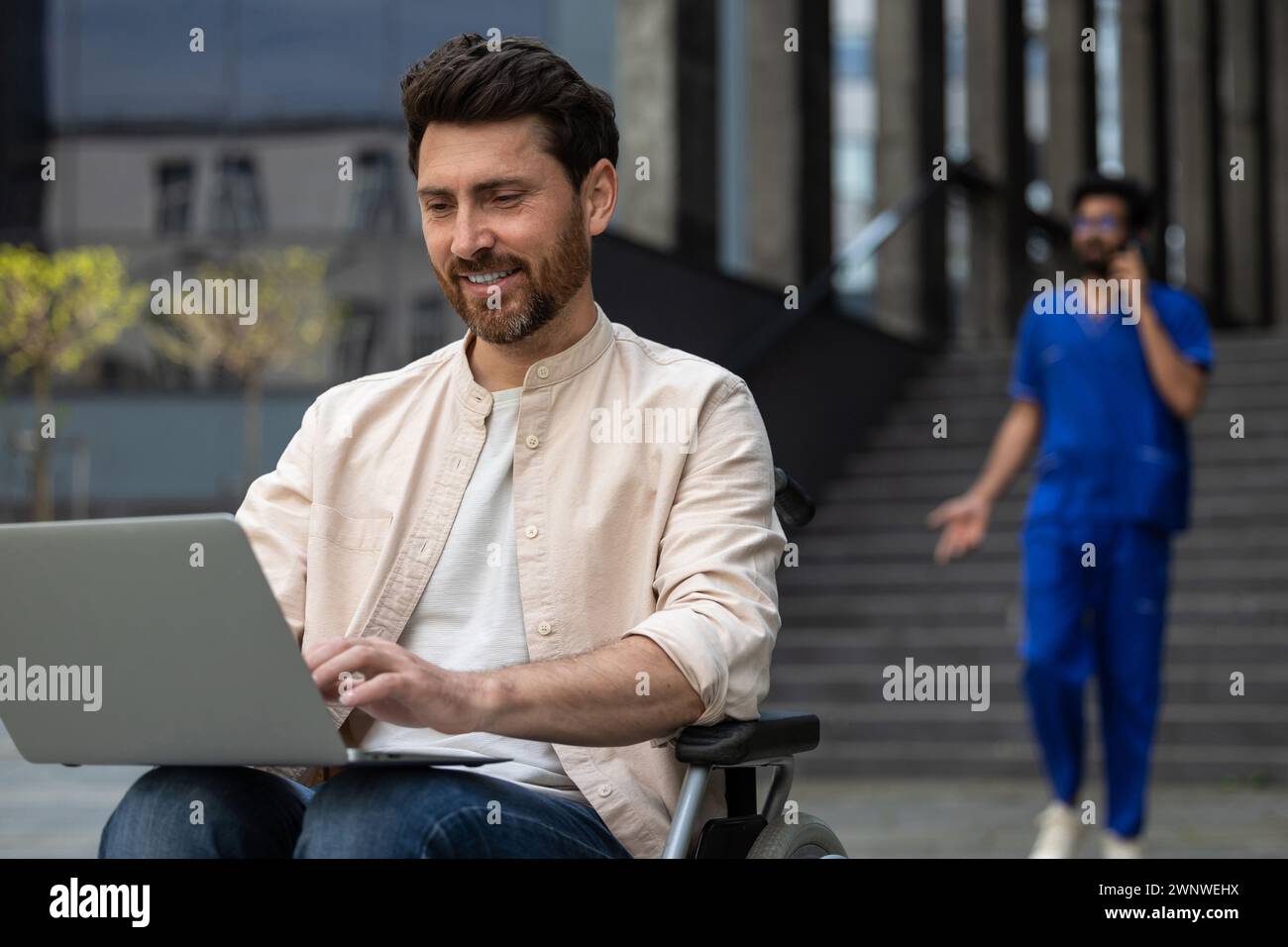 Disabled self-employed man working on laptop while sitting in ...