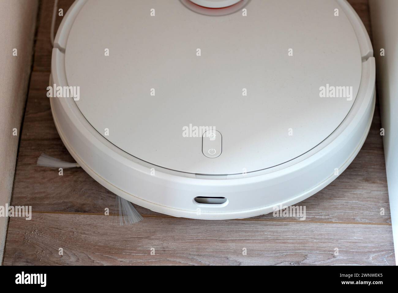 White robot vacuum cleaner. robotic exhauster is charging energy. top ...