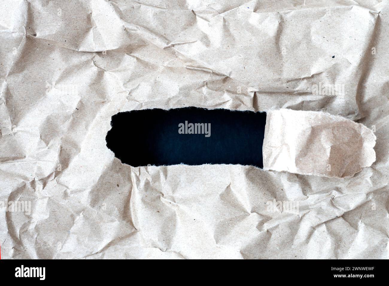 hole in paper with color paper background inside. Good paper texture ...