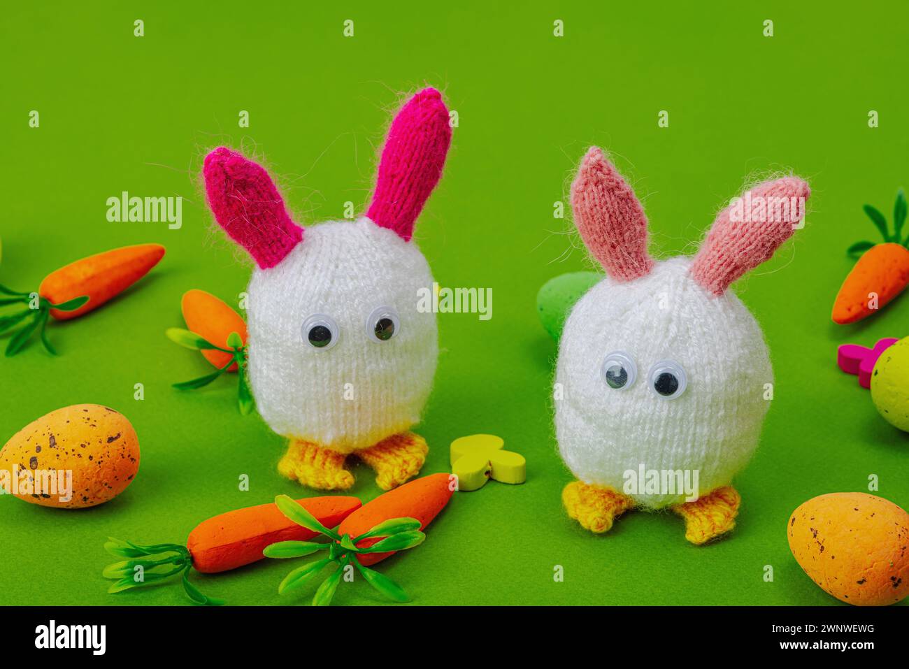 Handmade Easter concept. Knitted bunnies with traditional decoration ...