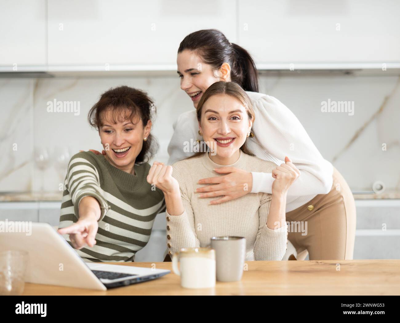 Women are sitting at computer and are immensely happy Stock Photo - Alamy