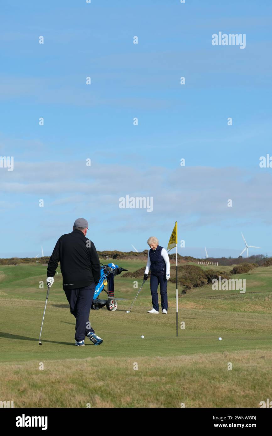 Mature lady playing golf at Portpatrick Galloway Scotland UK Stock ...