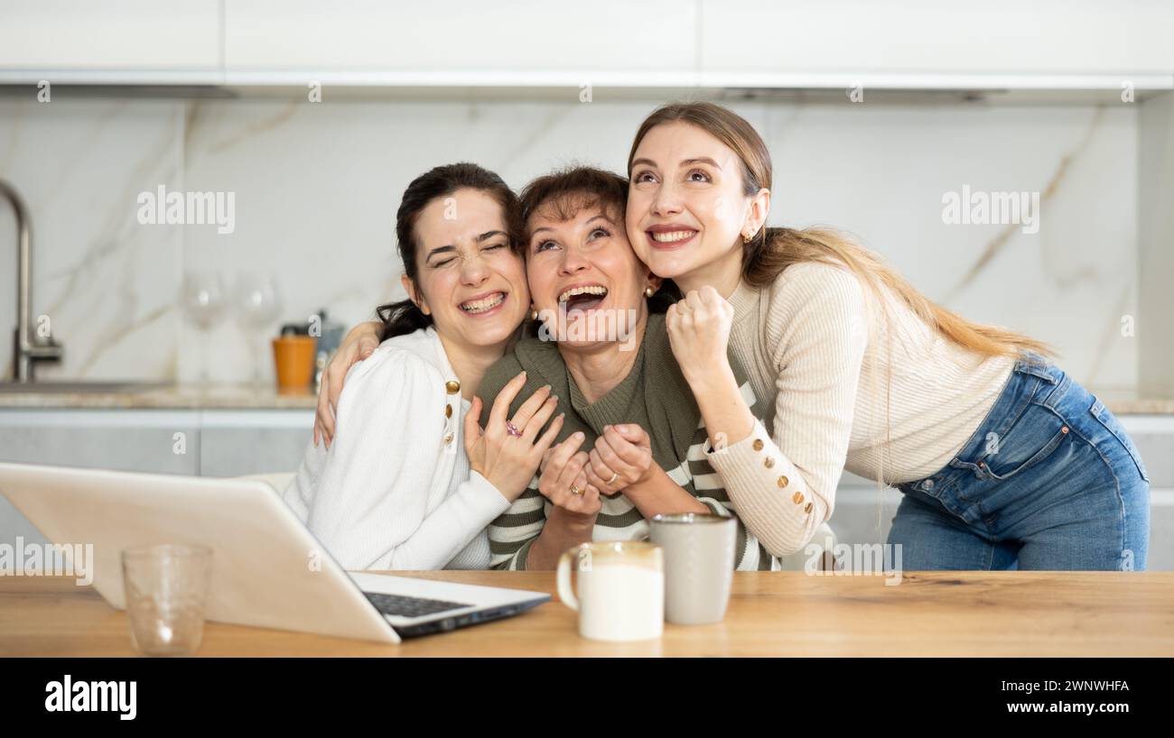 Women are sitting at computer and are immensely happy Stock Photo - Alamy