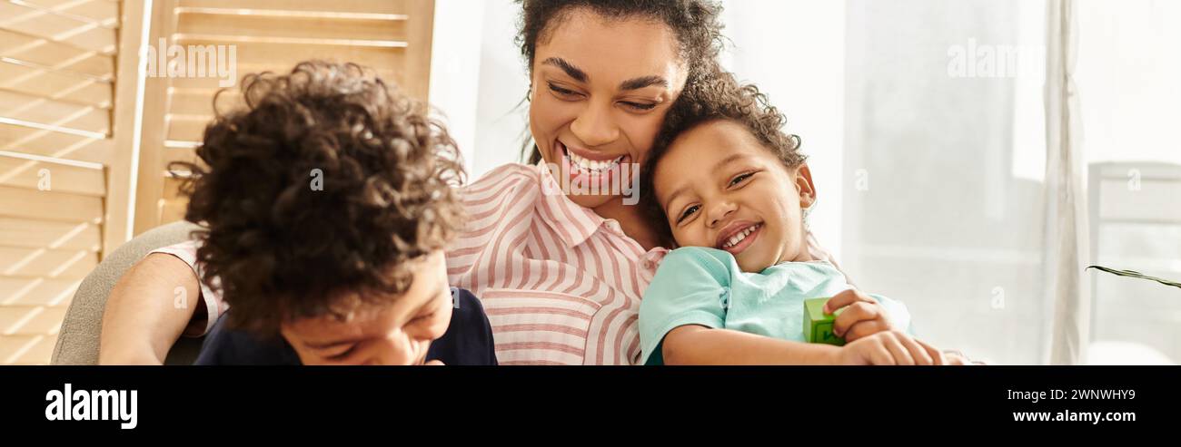 cheerful african american mother smiling and hugging warmly her ...