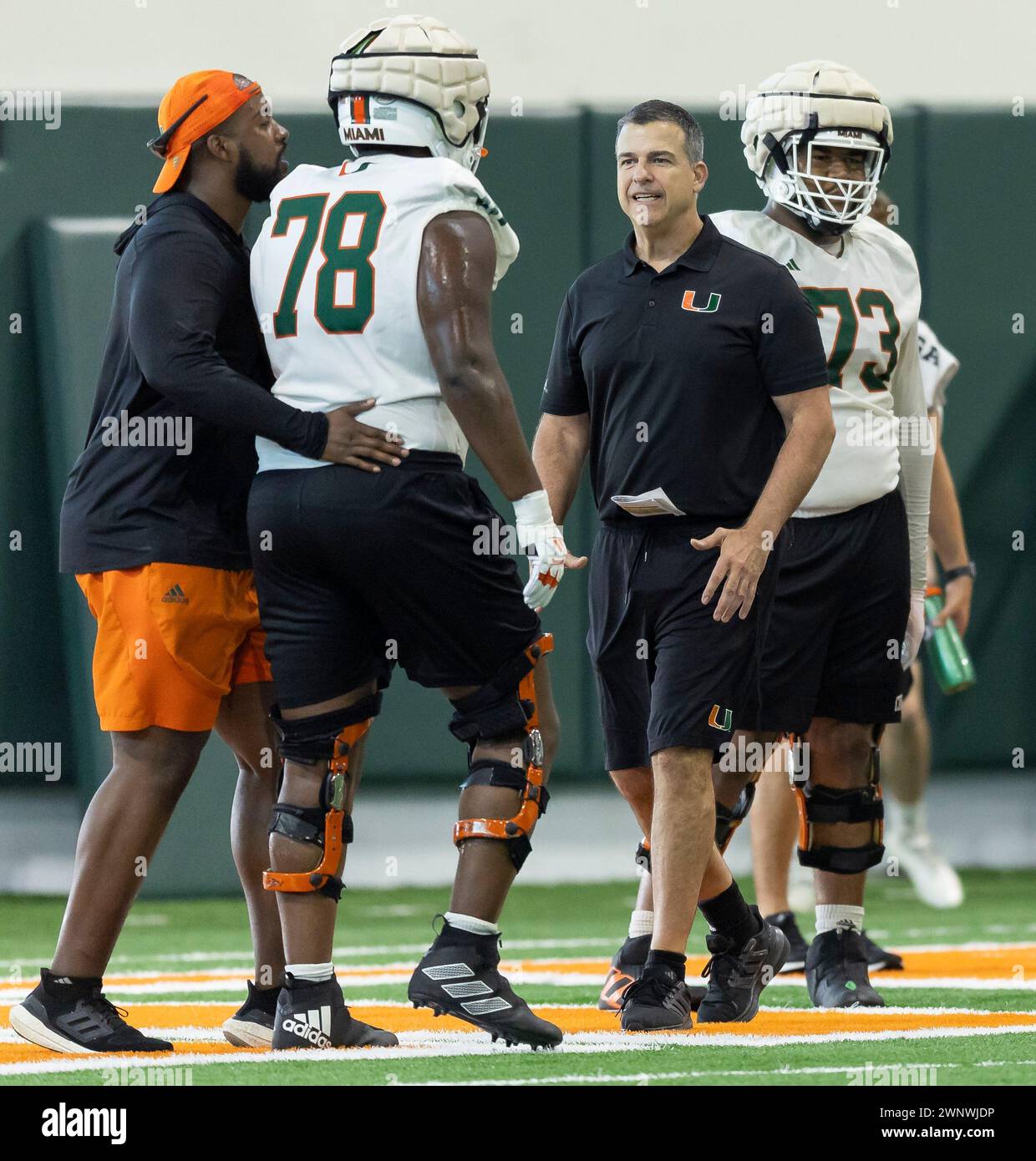Miami NCAA college football head coach Mario Cristobal talks to players ...