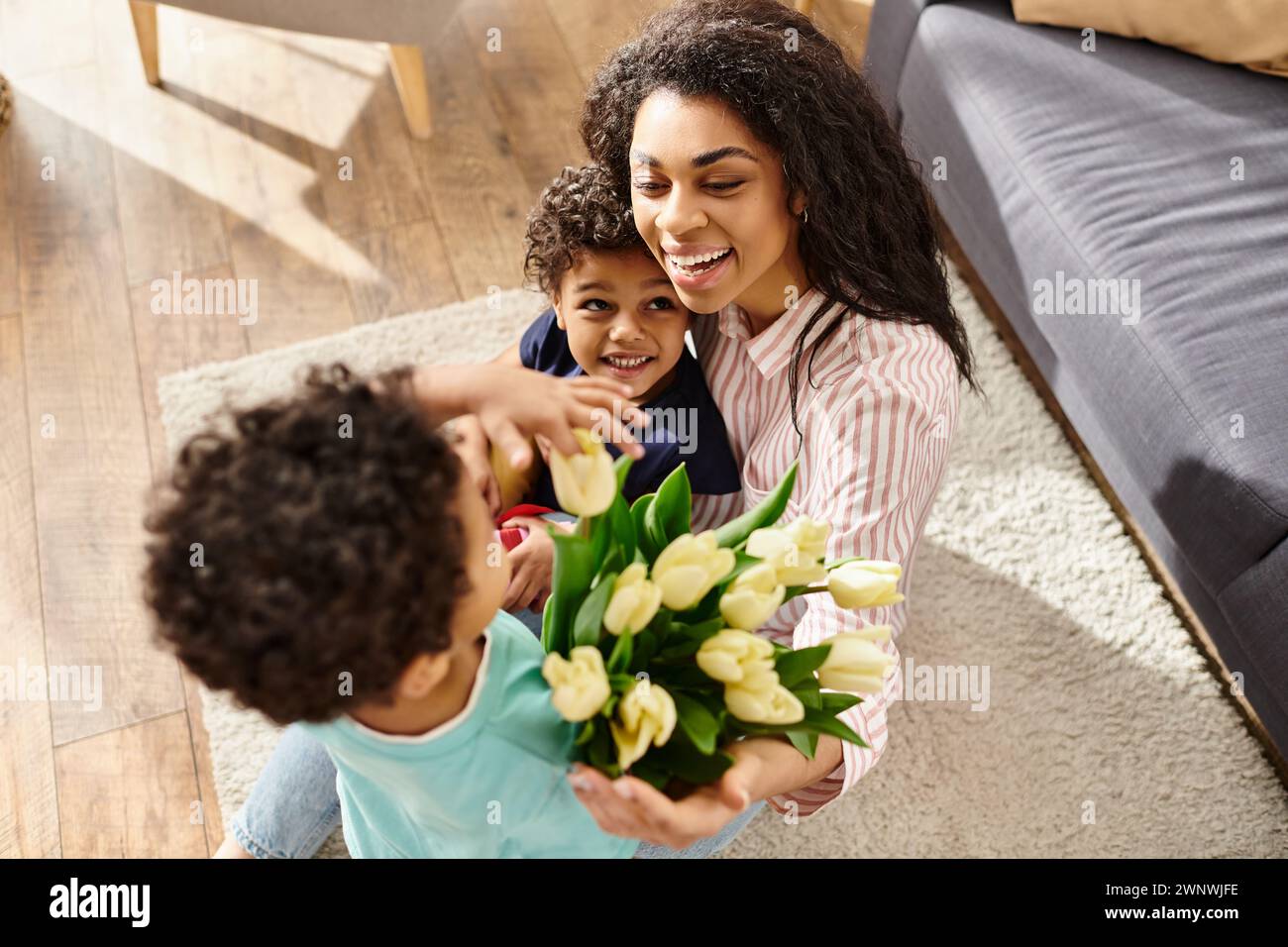joyous pretty african american woman receiving tulips from her cute ...