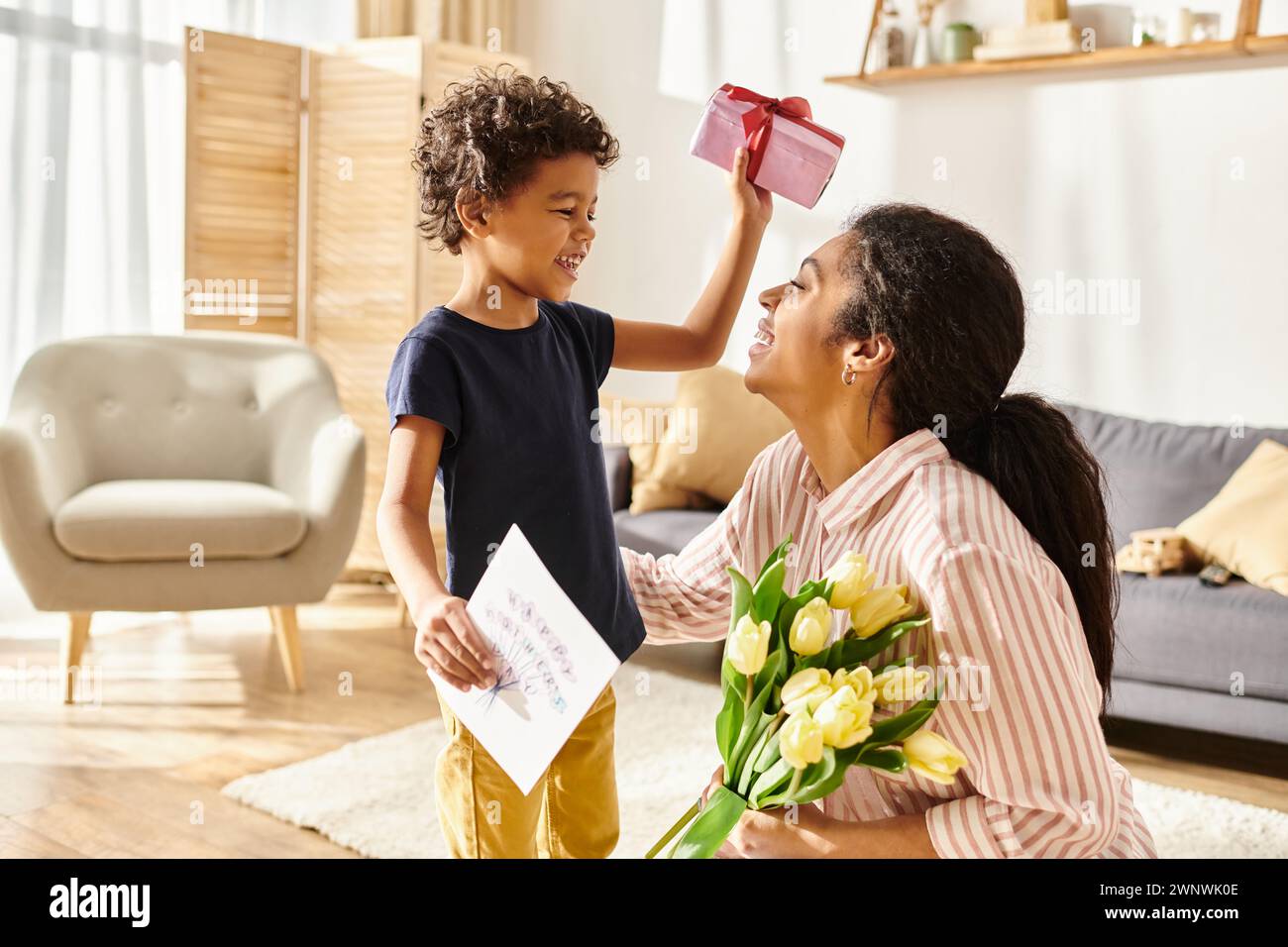 adorable african american boy giving present and postcard to his jolly ...