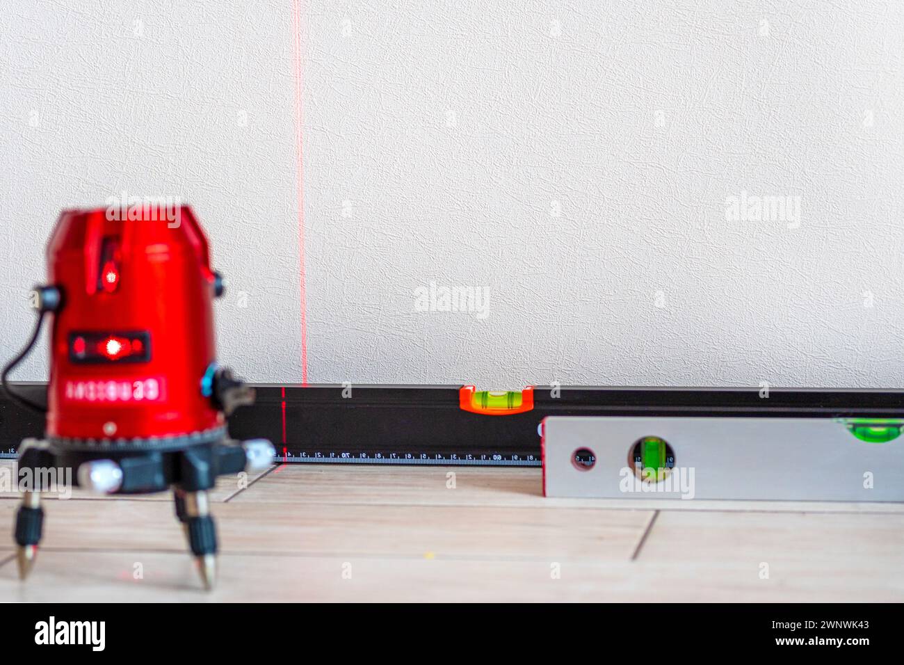 Laser level and Bubble levels, lines on the wall. measuring with red ...