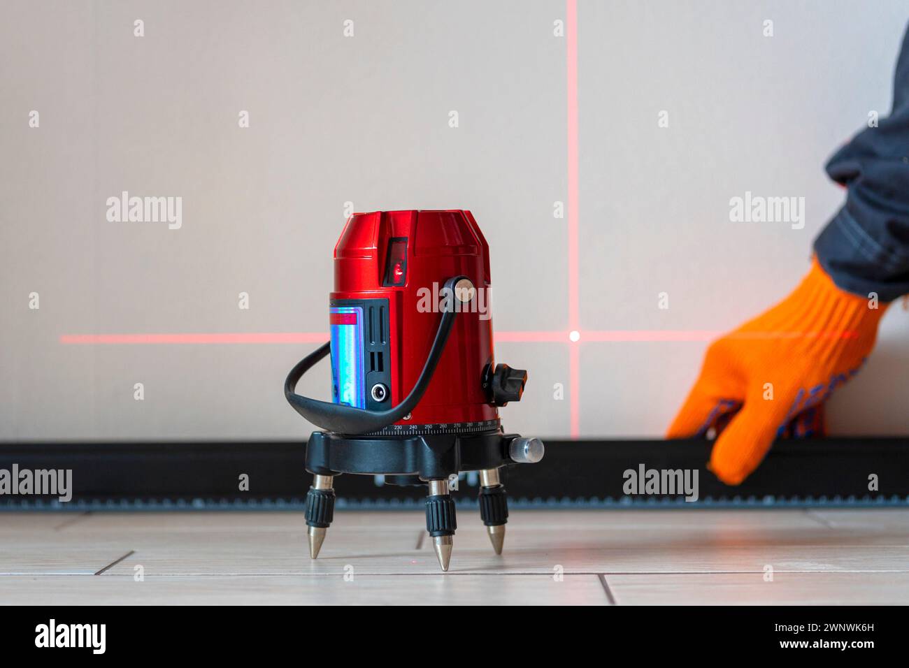 Worker and Bubble,laser level. lines on the wall. measuring with red ...