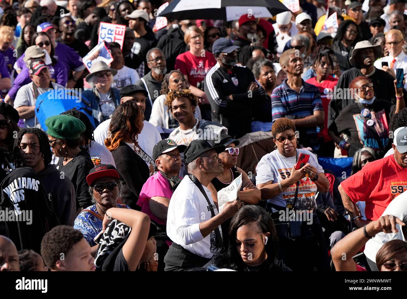 People gather to listen to speakers before walking across the Edmund ...