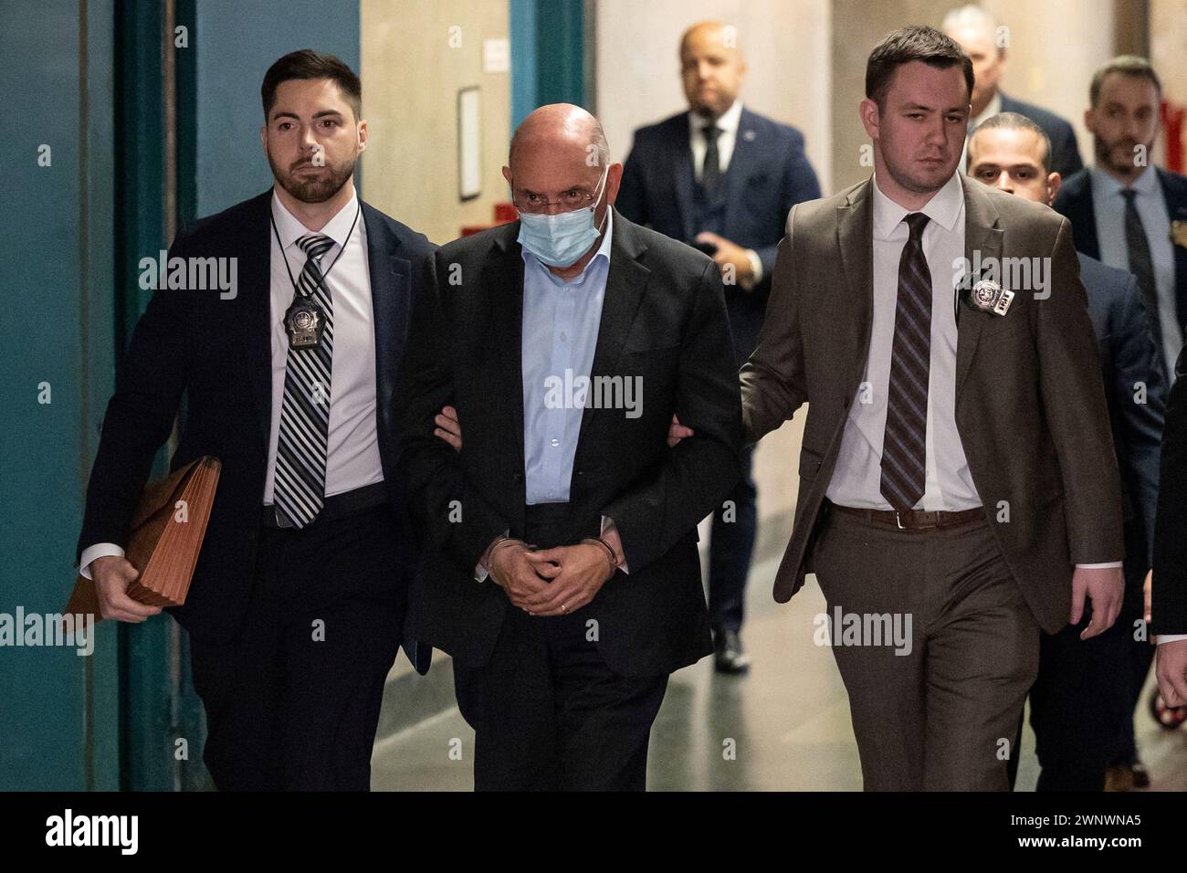 Allen Weisselberg, center, is escorted to Manhattan criminal court ...