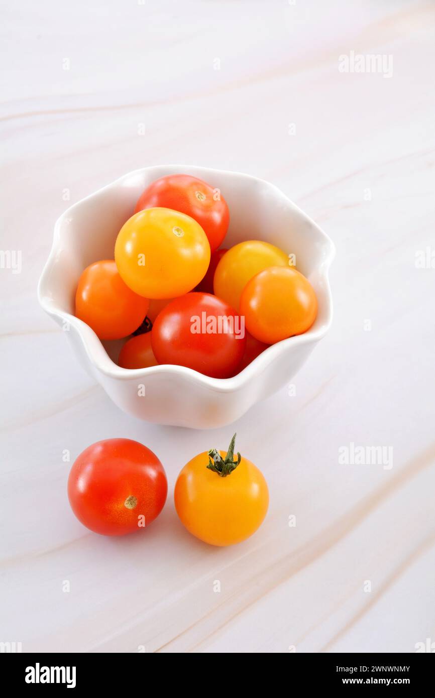 Ripe sweet organic red and yellow cherry tomatoes in pretty fluted ...