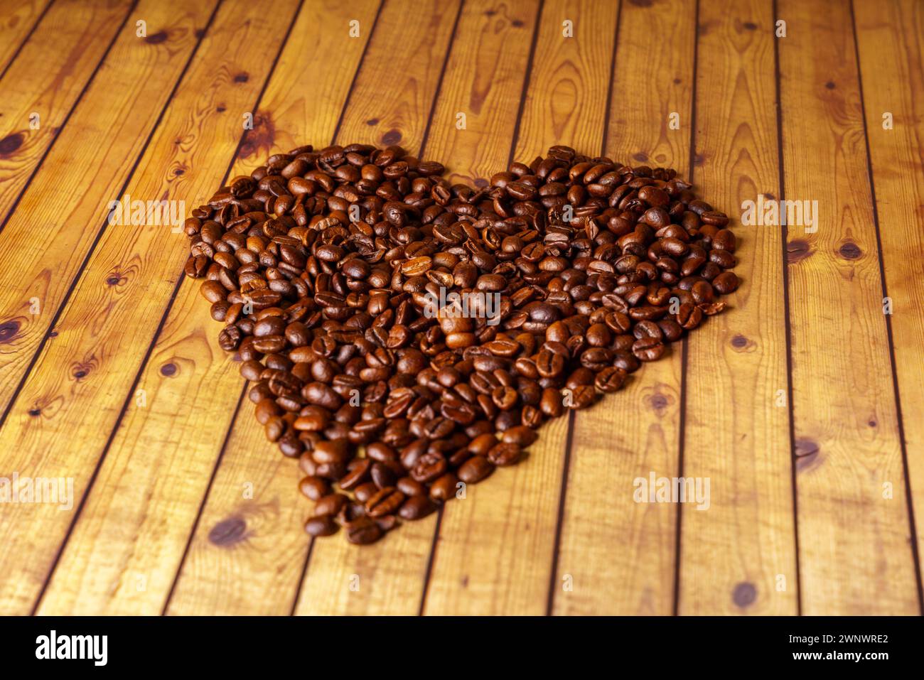 Heart shape made from coffee beans on wooden surface Stock Photo - Alamy
